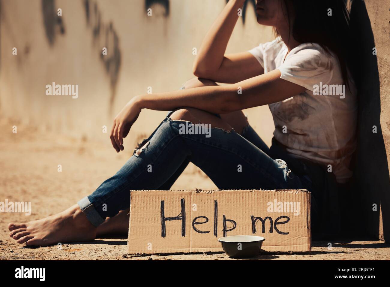 Poor woman begging for help on the street Stock Photo - Alamy