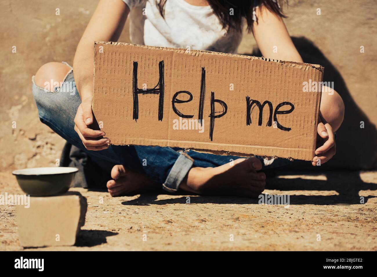 Poor woman begging for help on the street Stock Photo - Alamy