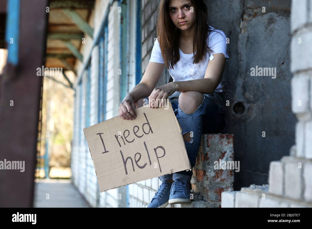 Poor woman begging for help on the street Stock Photo - Alamy