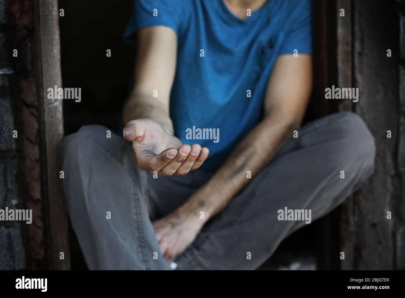 Poor man begging for help on the street Stock Photo - Alamy