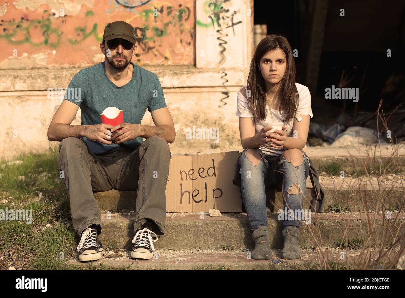Poor people sitting on the street Stock Photo - Alamy