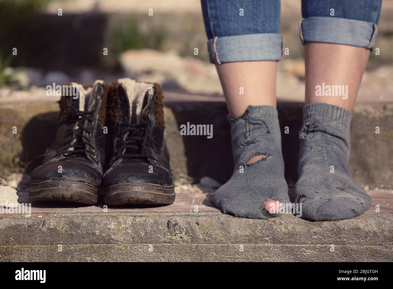 Poor woman wearing old dirty clothes Stock Photo - Alamy
