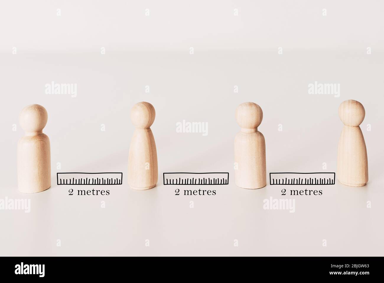 Representation of people keeping social distance, group of wooden ...