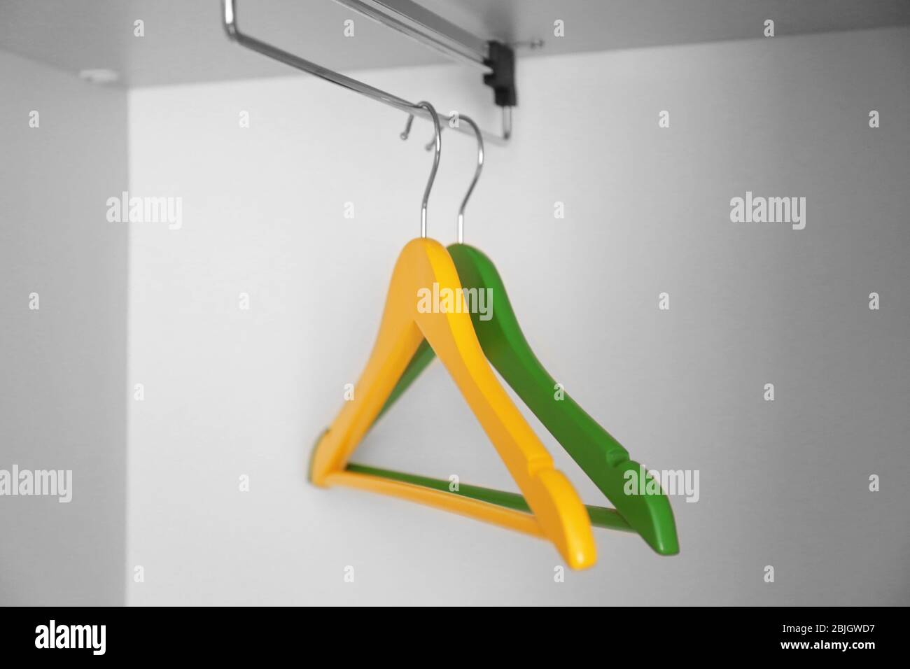 Two colour hangers in wardrobe Stock Photo - Alamy