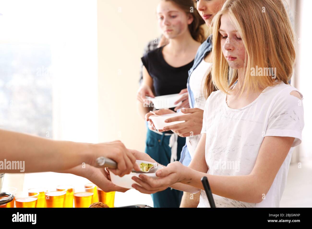 Volunteer giving food to poor people. Poverty concept Stock Photo - Alamy