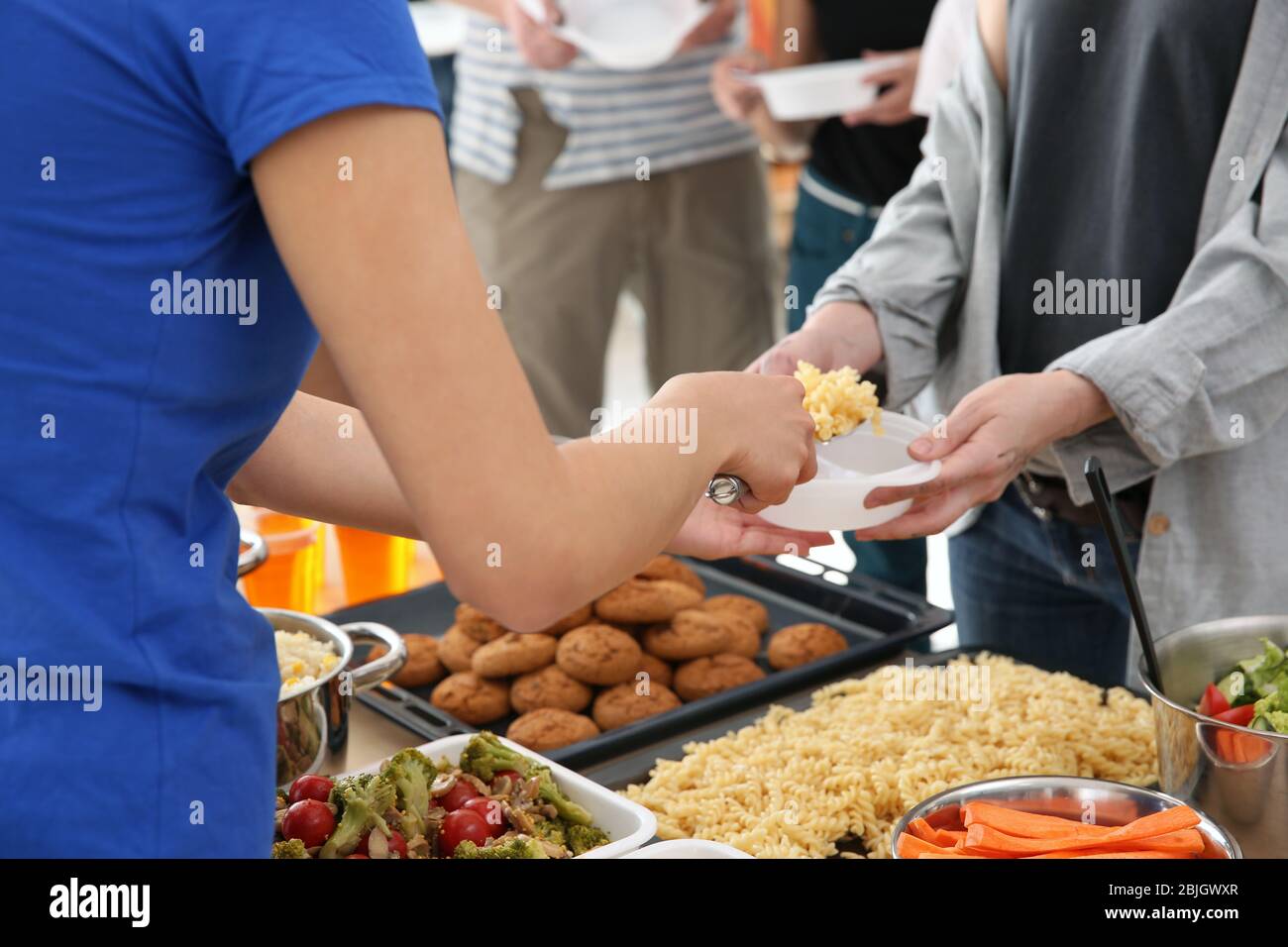 Volunteer sharing food with poor people. Poverty concept Stock Photo ...