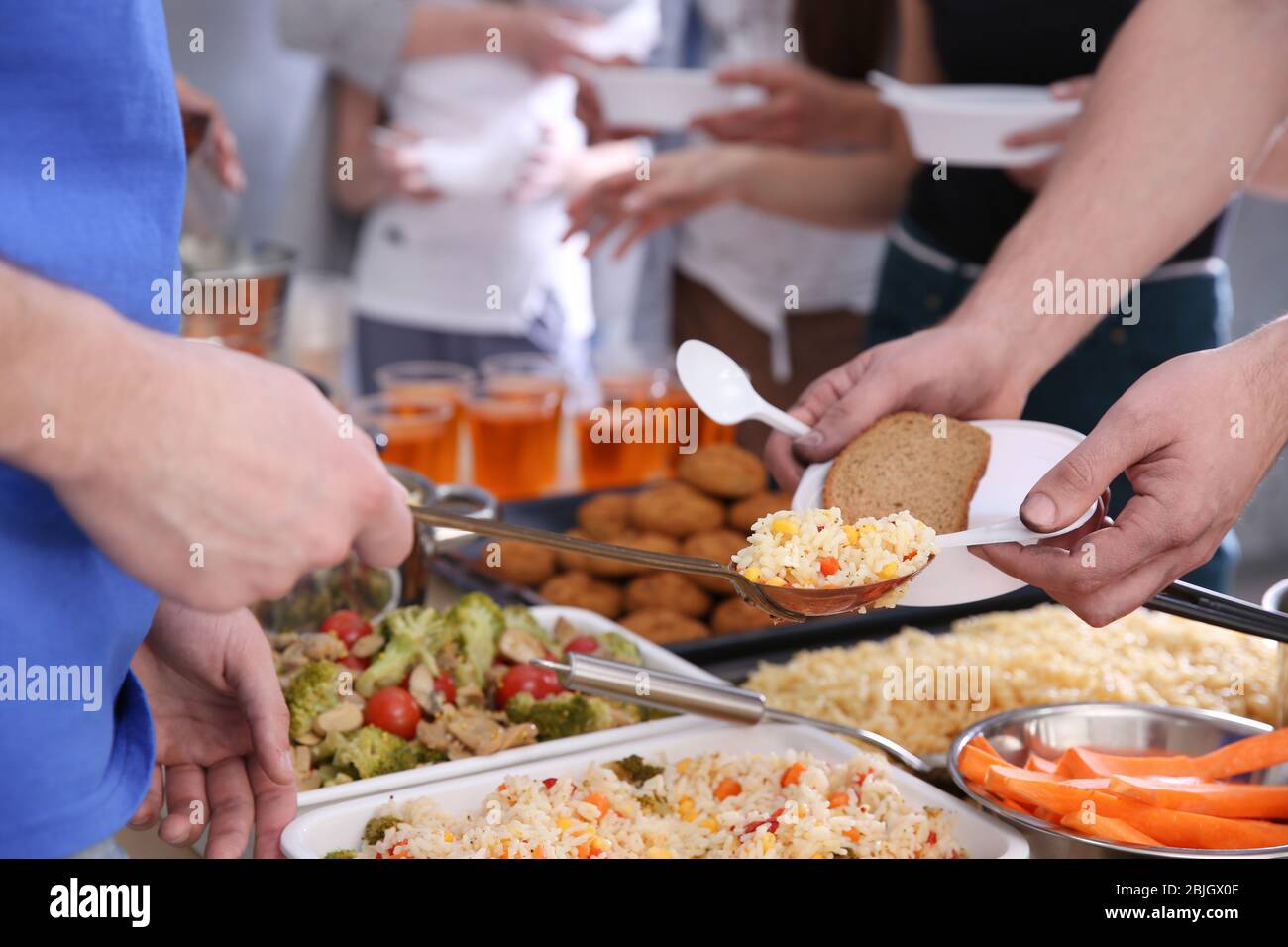 Volunteer sharing food with poor man. Poverty concept Stock Photo - Alamy