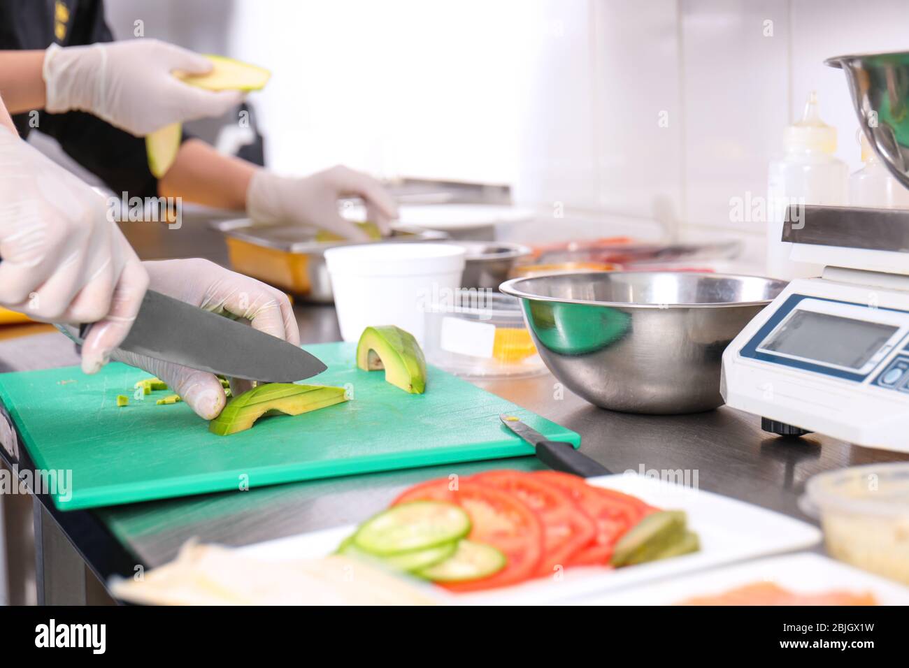 Female chef cutting avocado in kitchen Stock Photo - Alamy Female chef cutting avocado in kitchen Stock Photo - Alamy