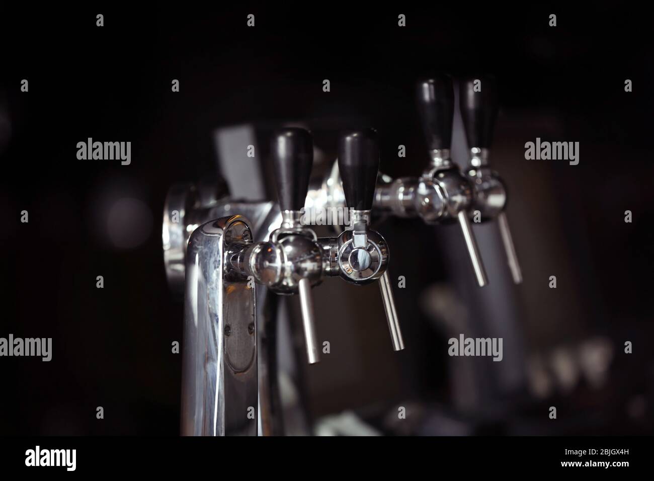 Beer taps on bar counter, closeup Stock Photo - Alamy