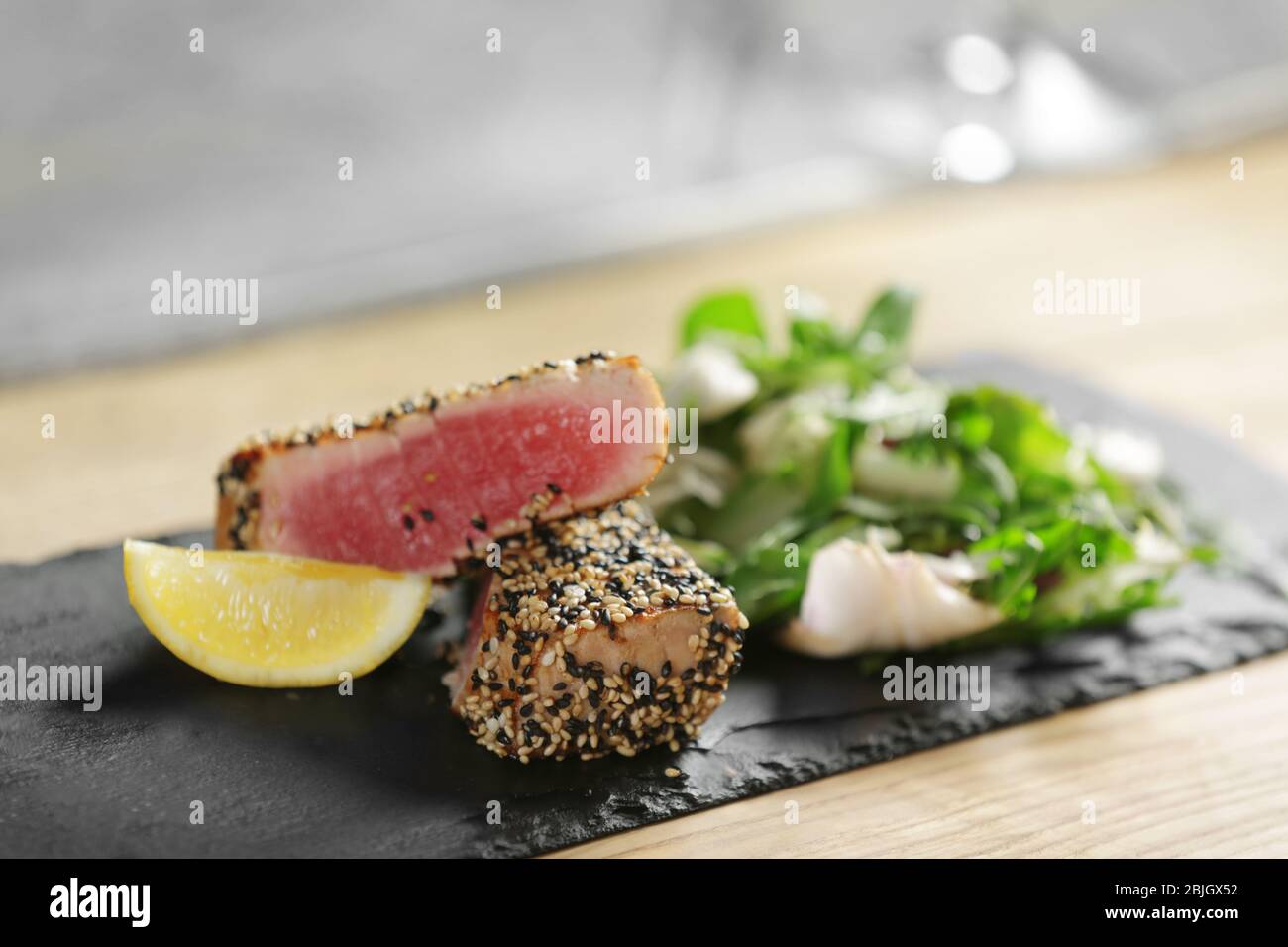 Slate plate with delicious tuna fillet on table Stock Photo - Alamy