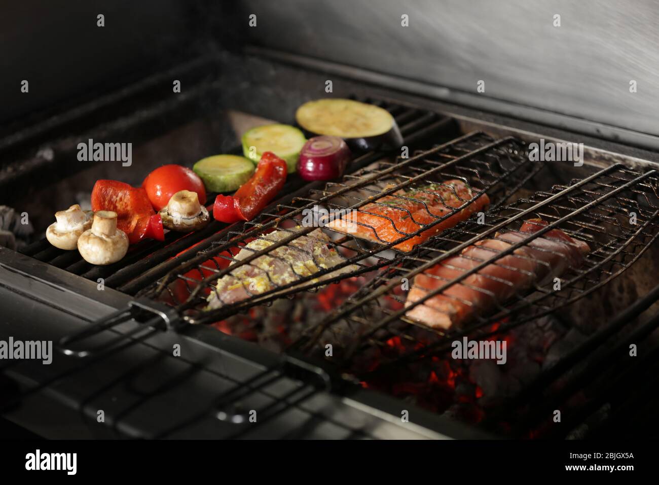 Delicious fish and vegetables on grill Stock Photo - Alamy