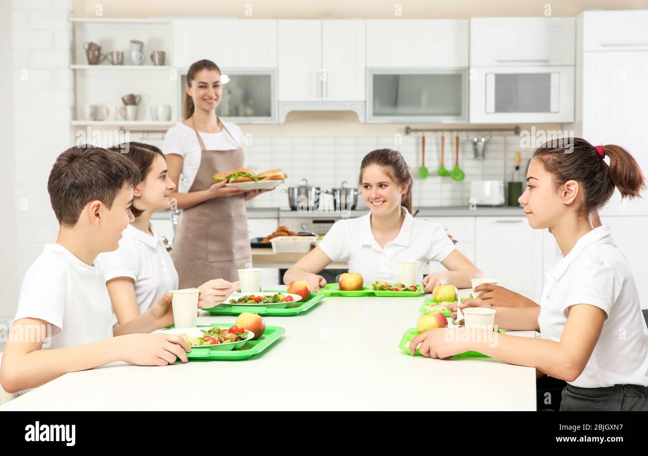 Boy with lunch tray in the lunch room at school hi-res stock ...