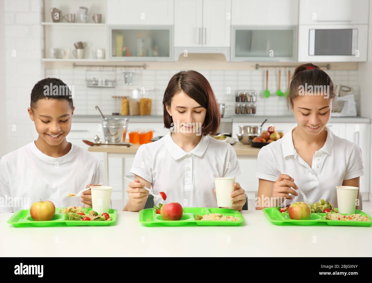 Boy with lunch tray in the lunch room at school hi-res stock ...