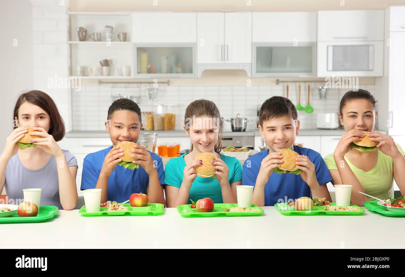 Children eating delicious sandwiches in school canteen Stock Photo - Alamy
