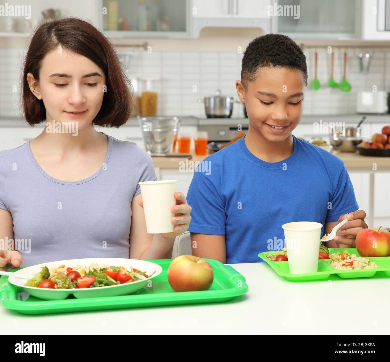 Boy with lunch tray in the lunch room at school hi-res stock ...