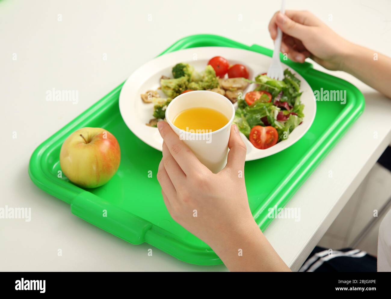 School boy eating delicious food at table Stock Photo - Alamy
