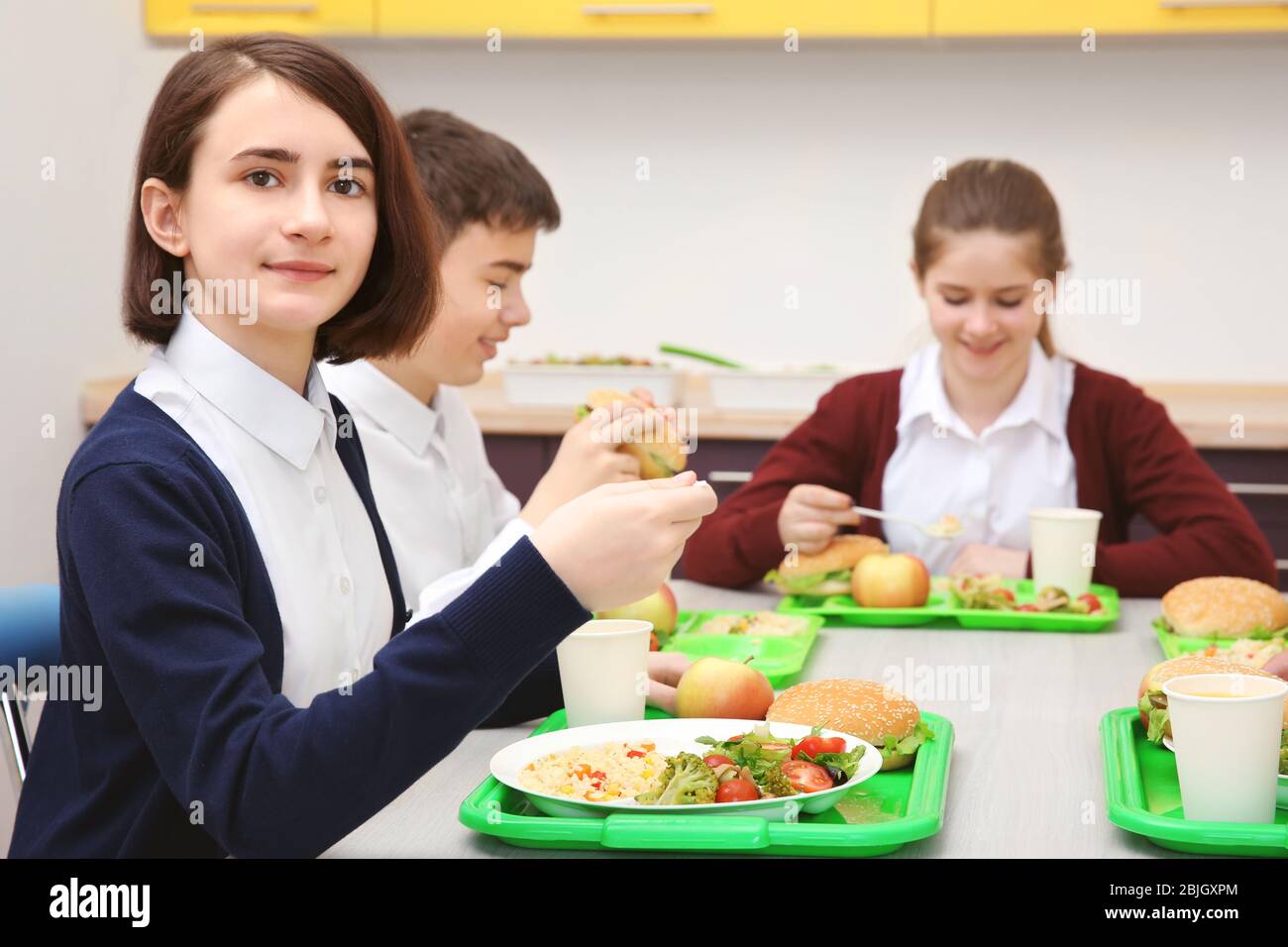 Boy with lunch tray in the lunch room at school hi-res stock ...