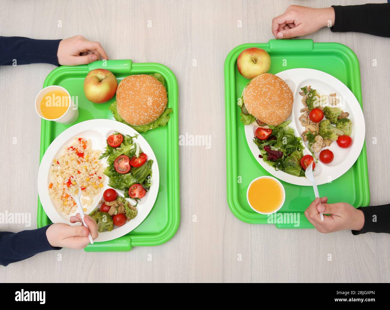 Children sitting at table in school cafeteria while eating lunch Stock ...