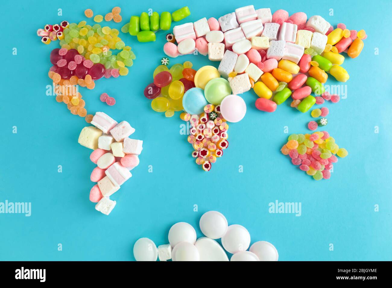 Map of world made from different candies on blue background Stock Photo ...