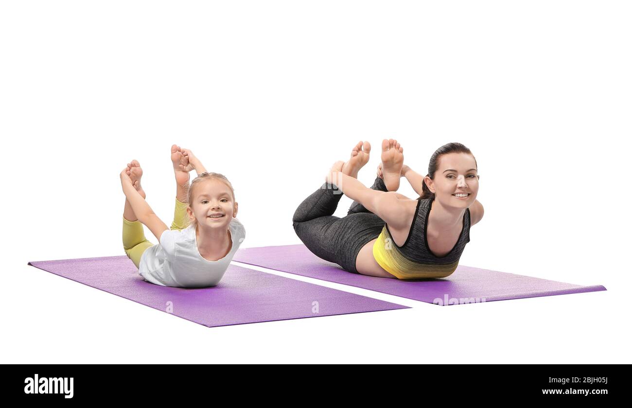 Mother and daughter doing exercise on white background Stock Photo - Alamy