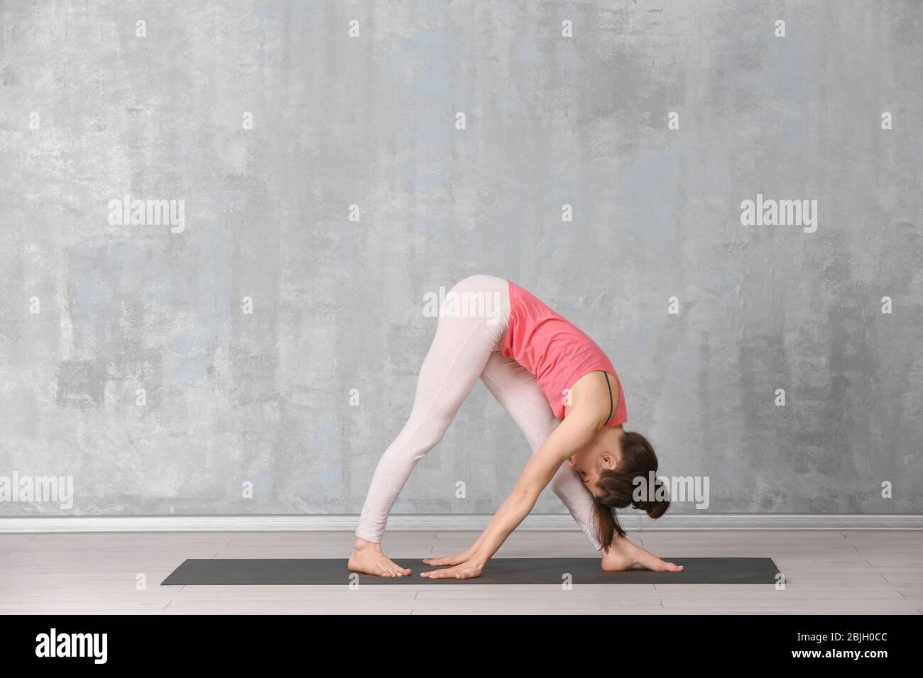 Woman practicing triangle pose hi-res stock photography and images - Alamy
