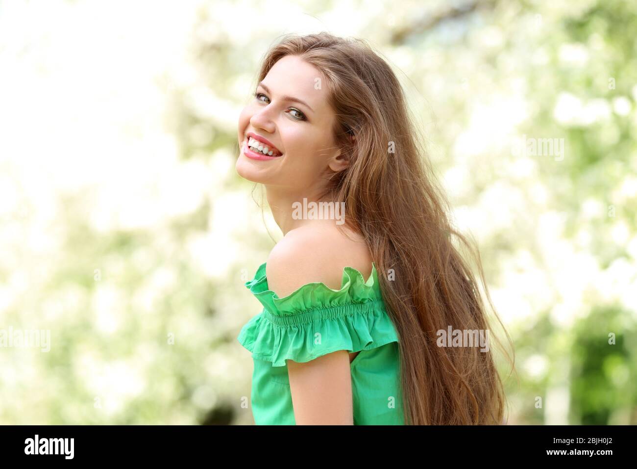 Young beautiful woman walking in spring park Stock Photo - Alamy