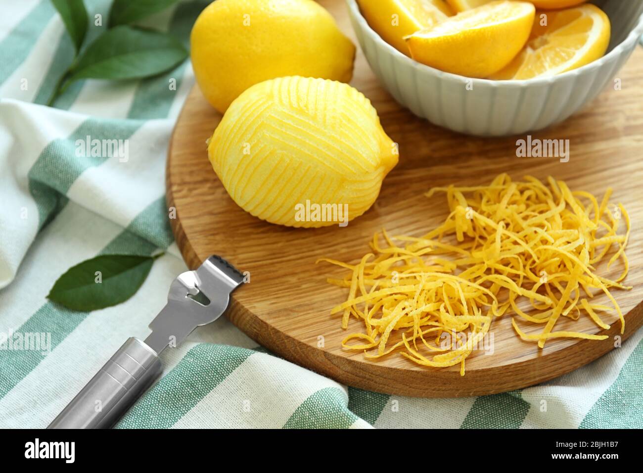 Composition with lemons, zest and special tool on table Stock Photo - Alamy