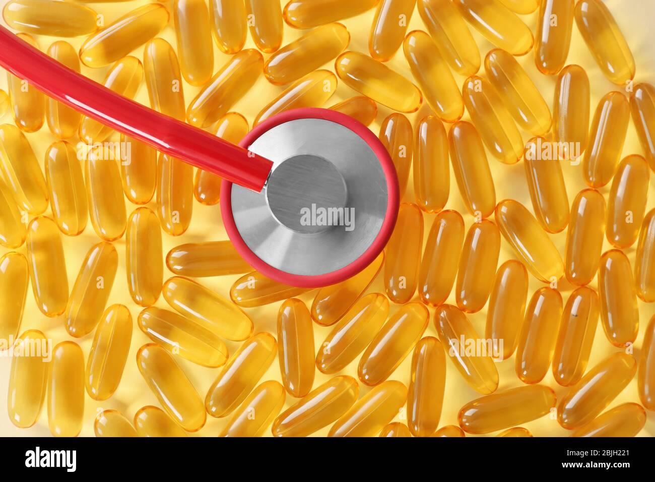 Fish oil capsules with stethoscope, closeup Stock Photo - Alamy