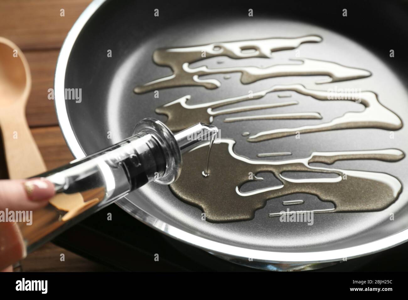 Woman pouring oil hi-res stock photography and images - Alamy