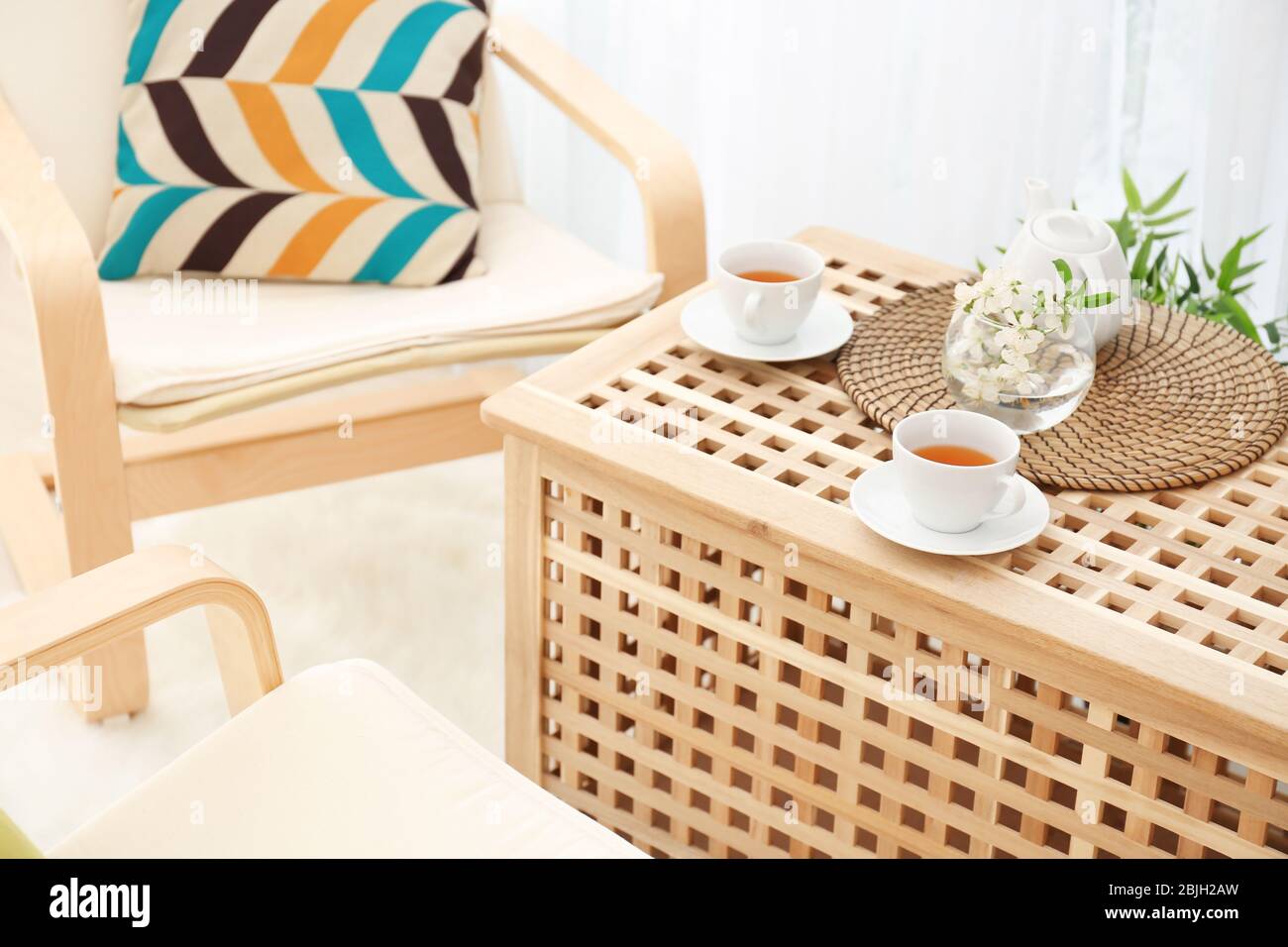 Wooden coffee table in modern veranda interior Stock Photo - Alamy