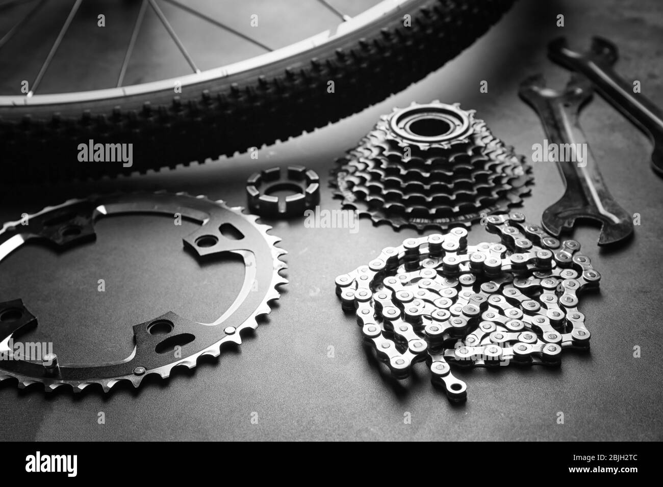 Bicycle parts and tools on gray background Stock Photo - Alamy