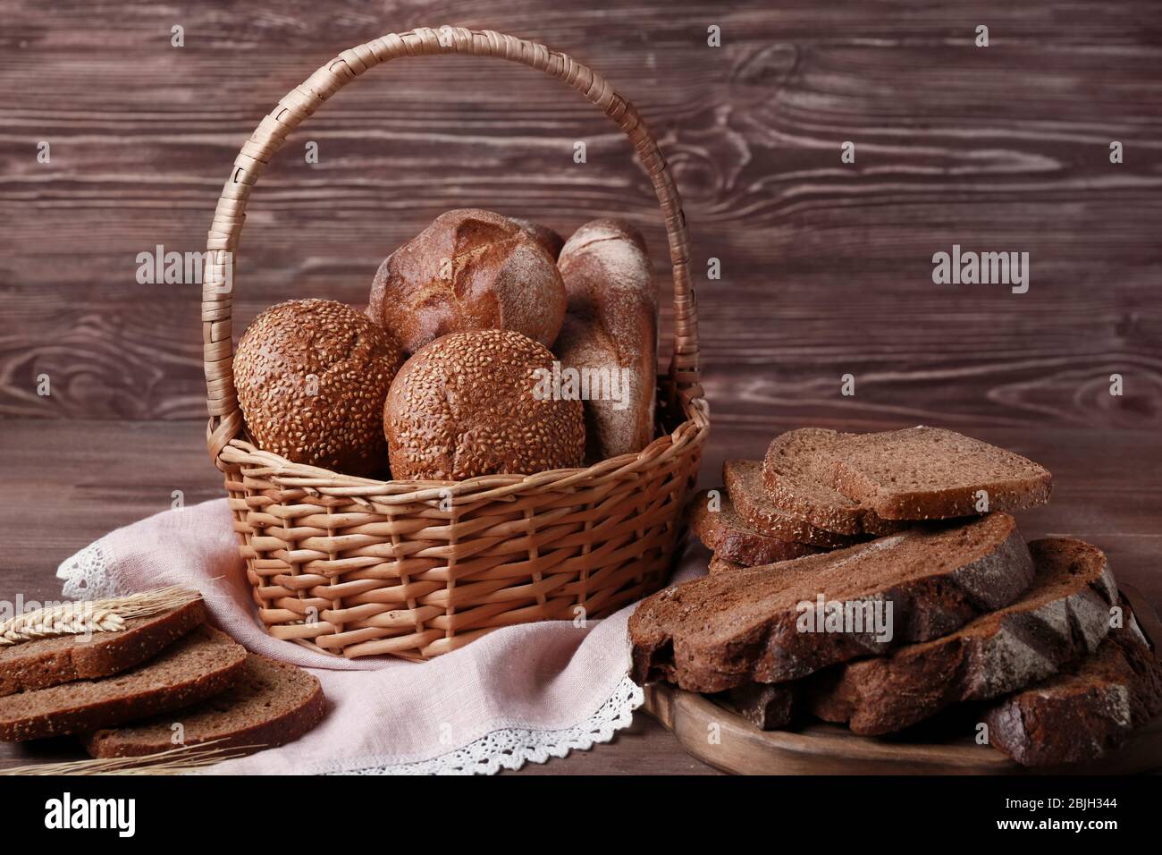 Basket with rye bread on wooden background Stock Photo - Alamy