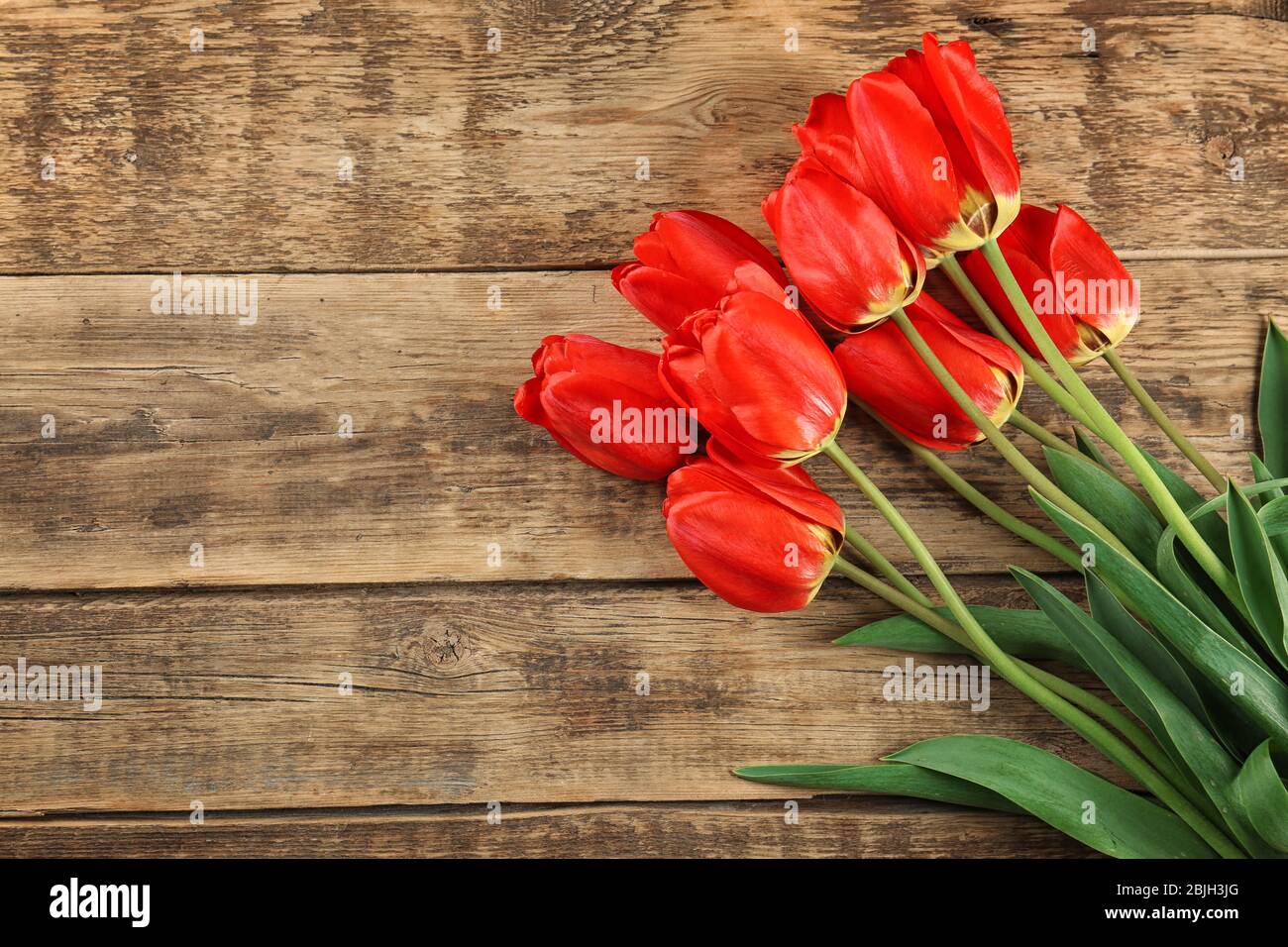 Bouquet of beautiful tulips on wooden background Stock Photo - Alamy