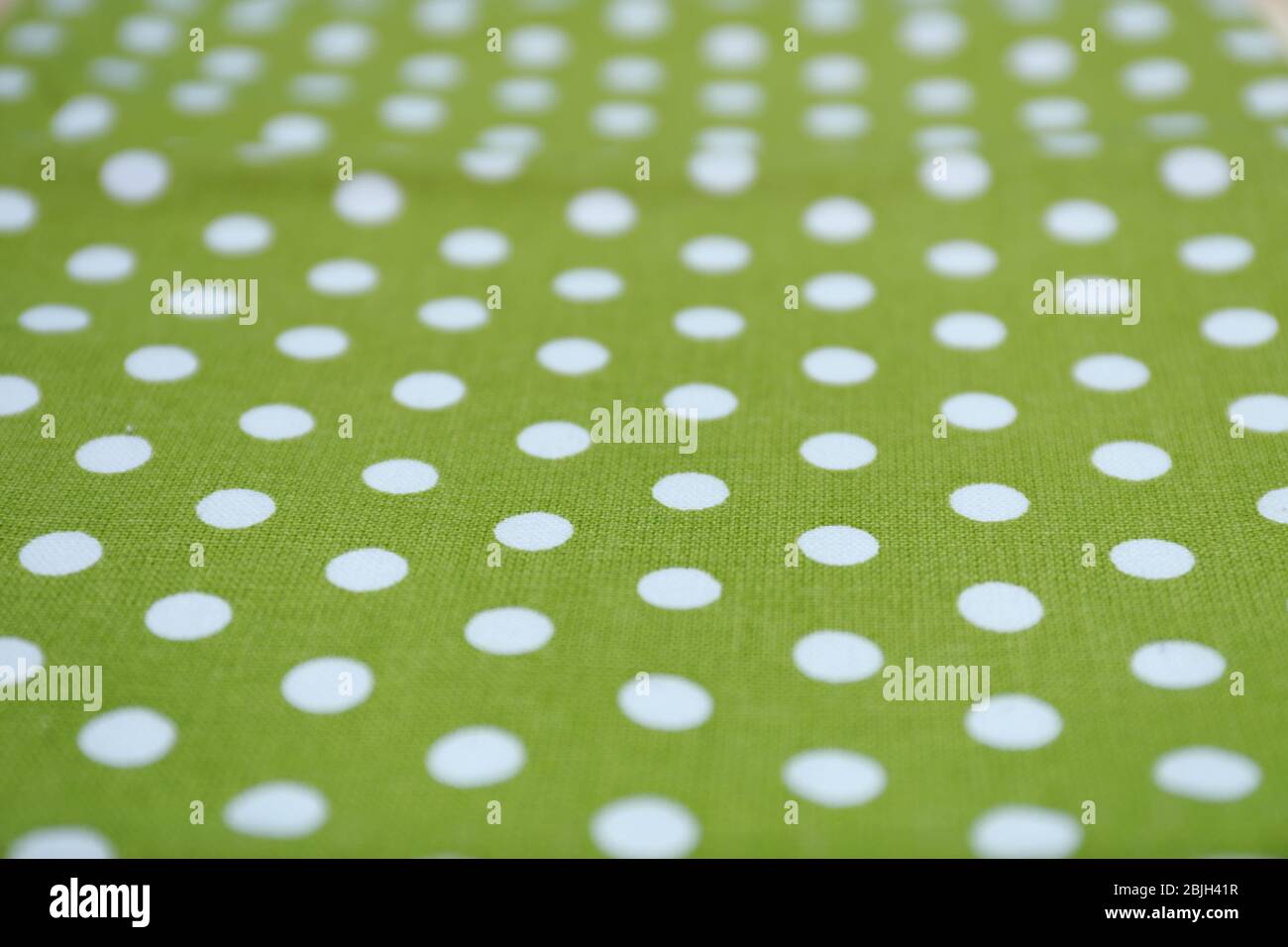 Green spotted cloth as background, closeup Stock Photo - Alamy