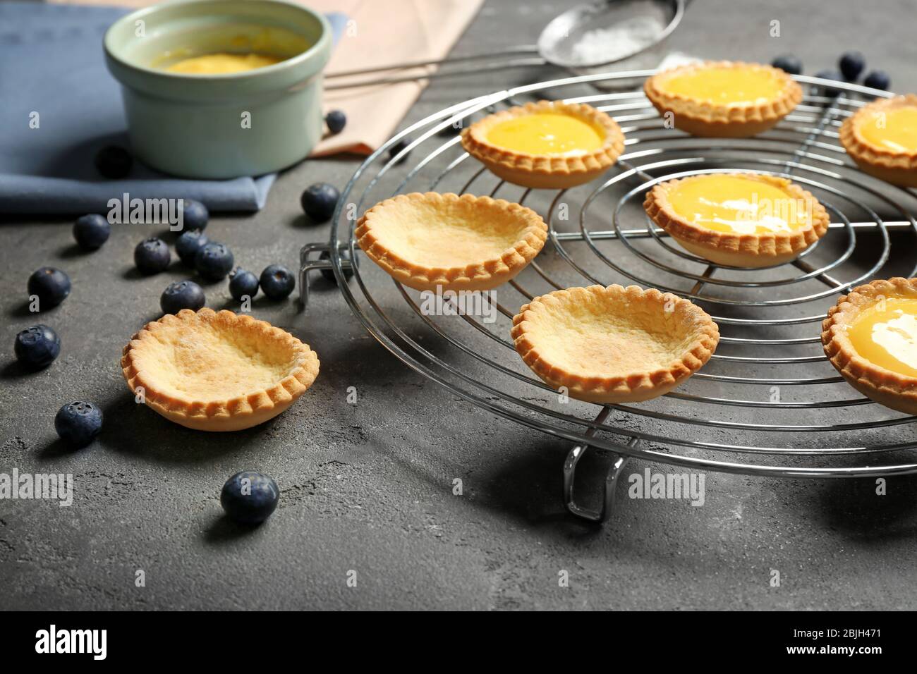 Cooling rack with delicious crispy tarts on table Stock Photo - Alamy