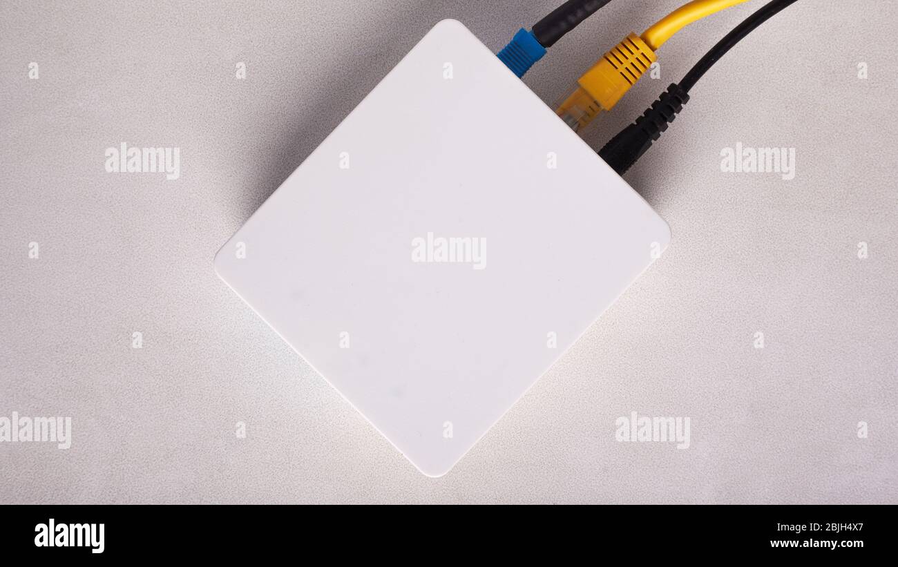 Wi-Fi router modem with connected cables on a white background close-up ...