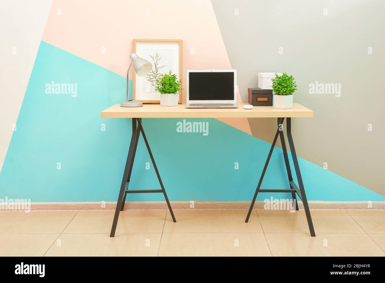Workplace with computer in room near color wall Stock Photo - Alamy