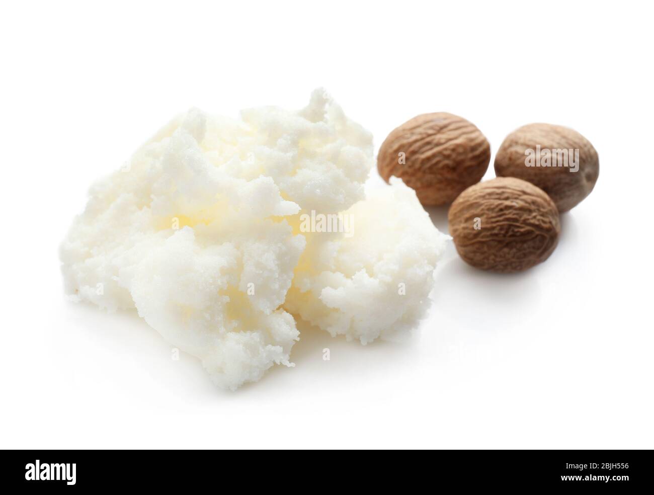 Shea butter and nuts on white background Stock Photo - Alamy