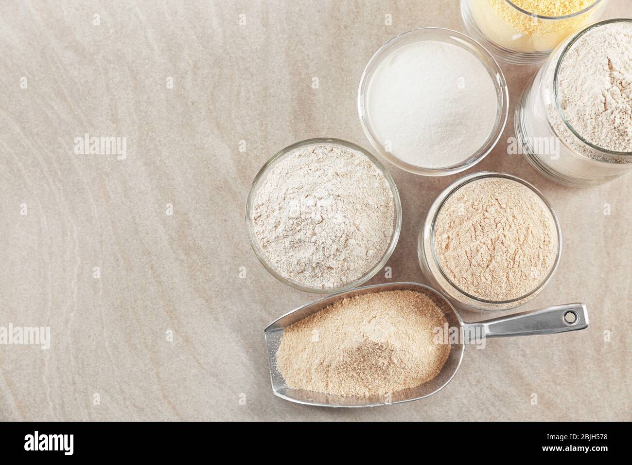 Composition with different types of flour on table Stock Photo - Alamy