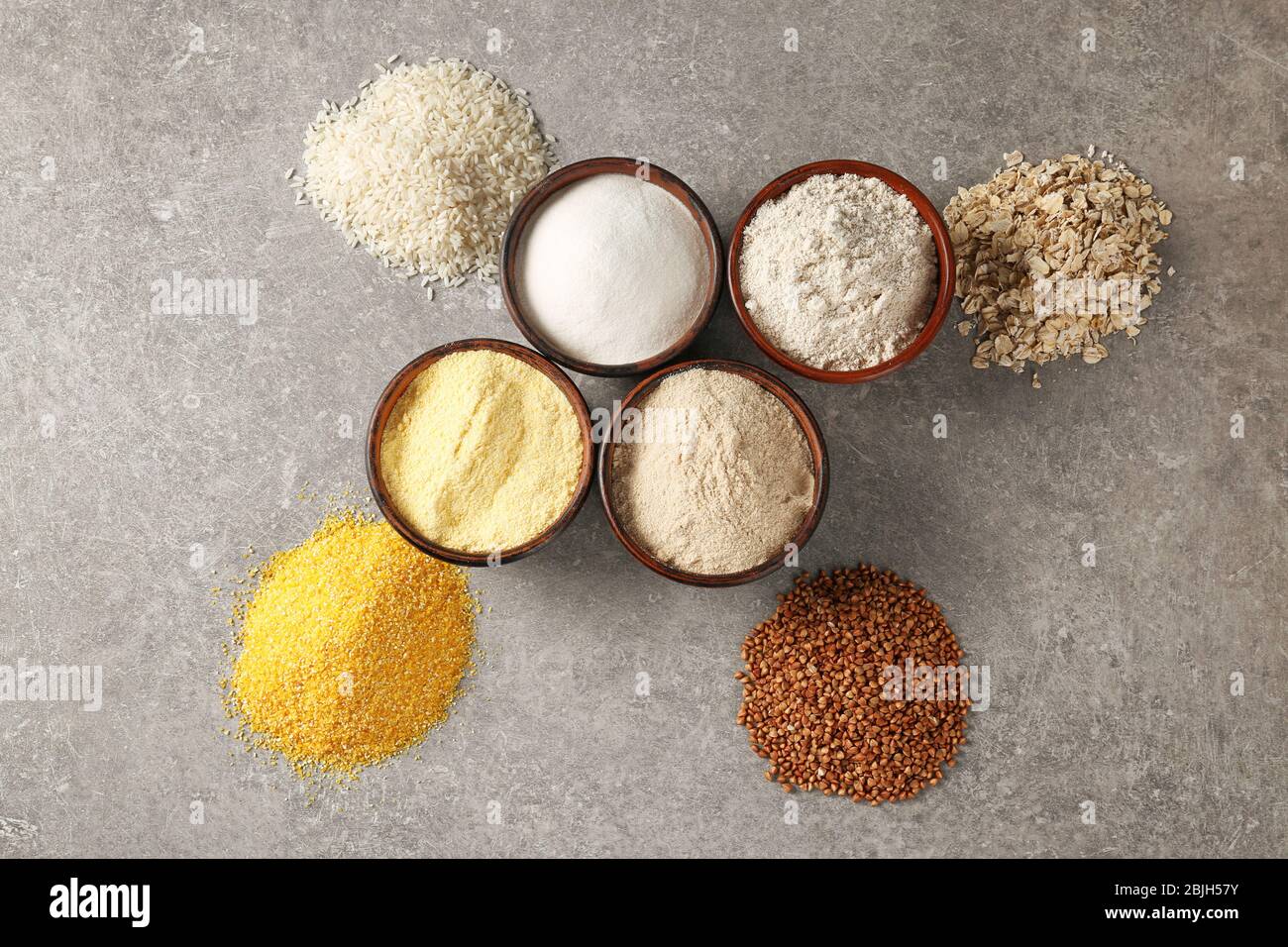 Bowls with different types of flour on gray background Stock Photo - Alamy