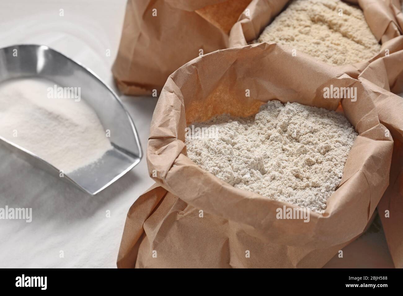 Paper bags with different types of flour on table, closeup Stock Photo ...