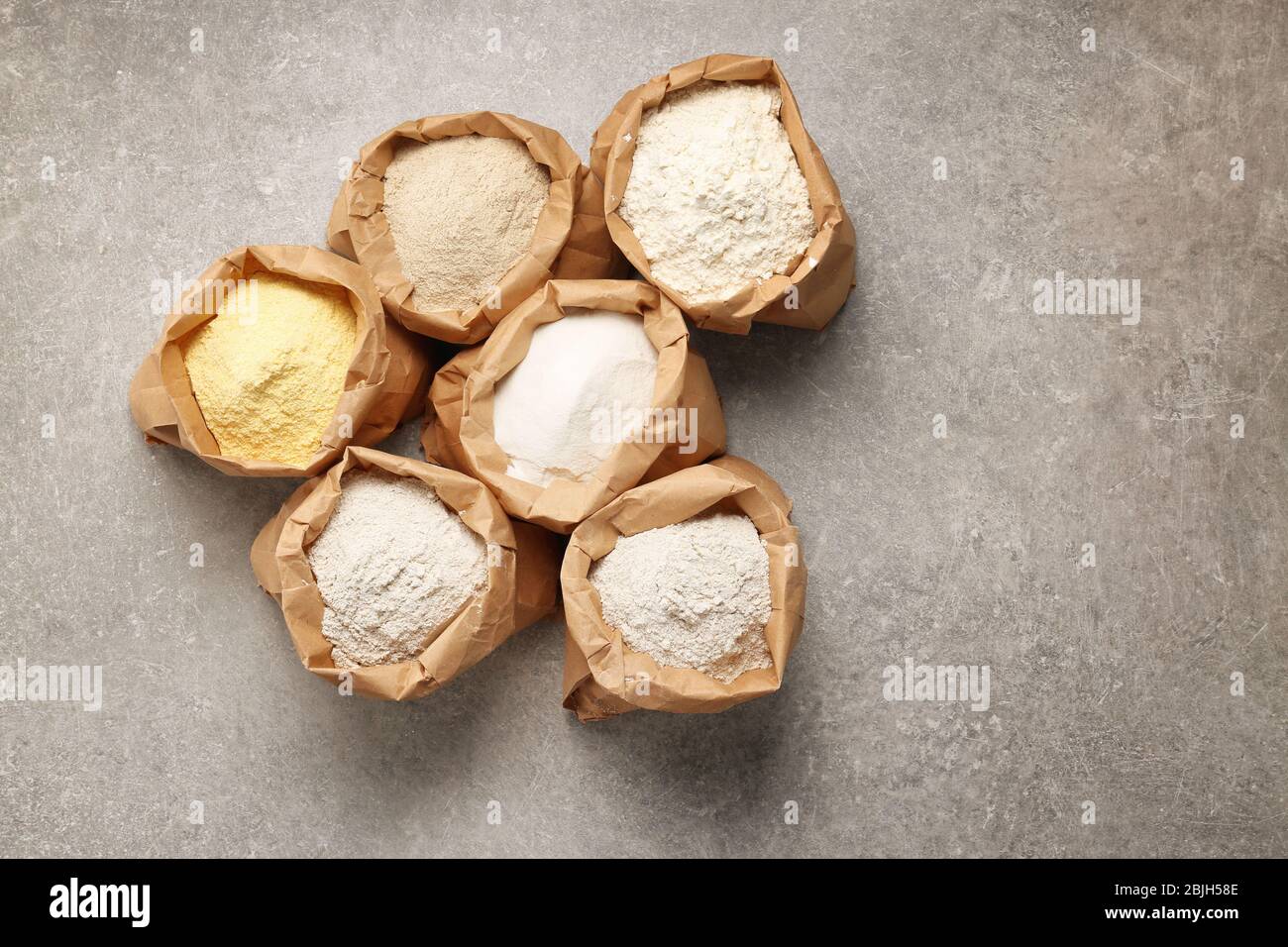 Paper bags with different types of flour on table Stock Photo - Alamy