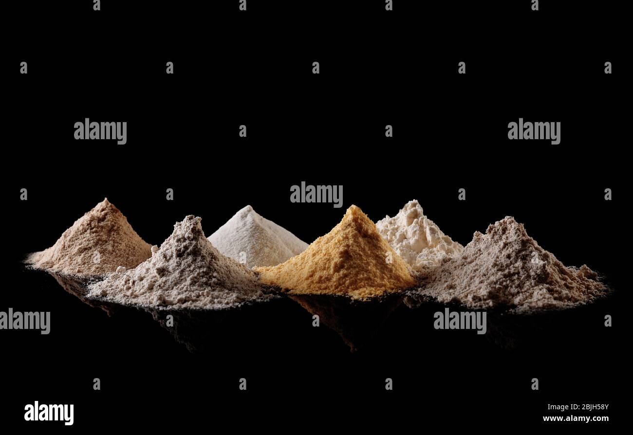 Different types of flour on black background Stock Photo - Alamy