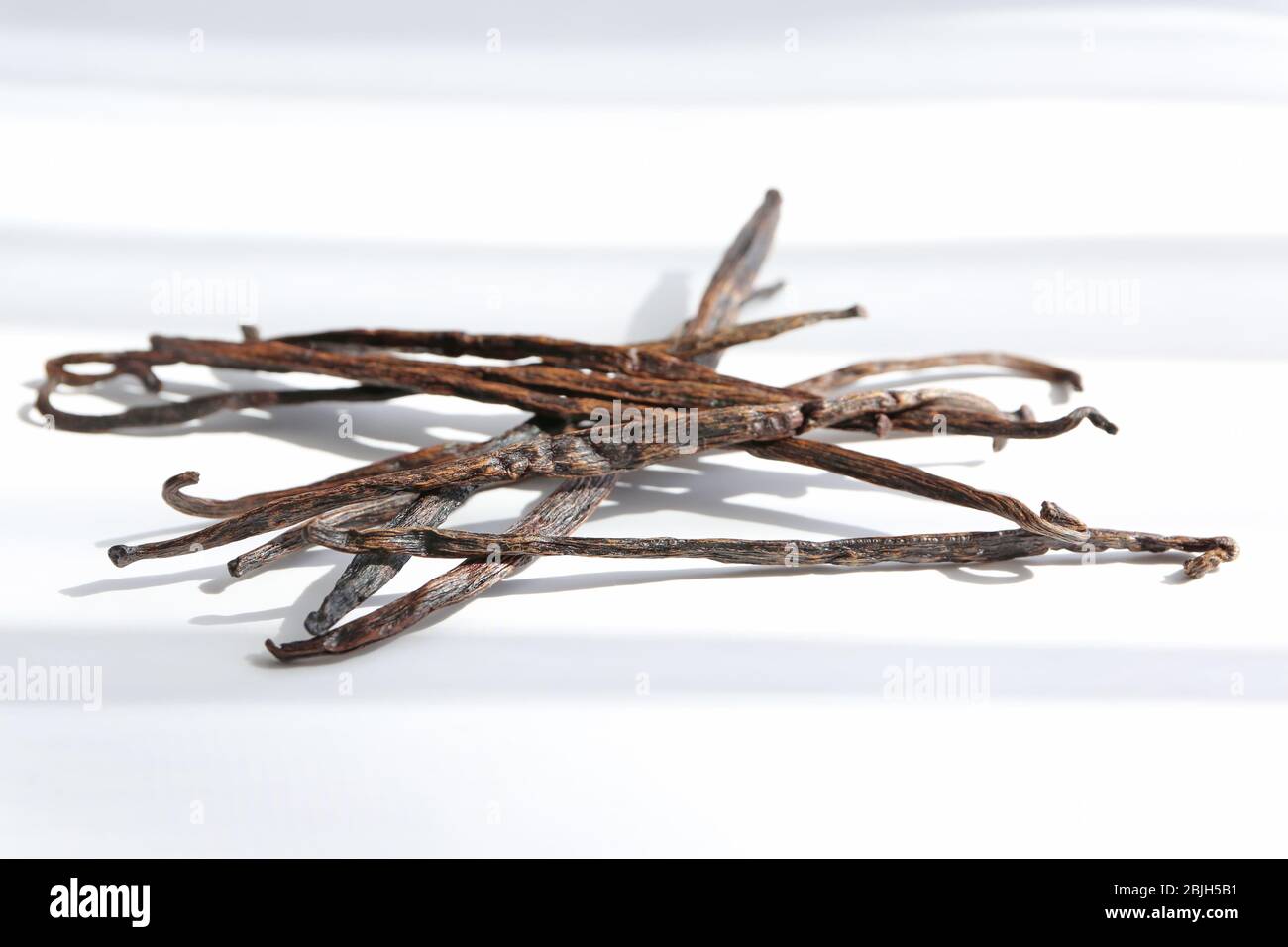 Vanilla pods on white background Stock Photo - Alamy