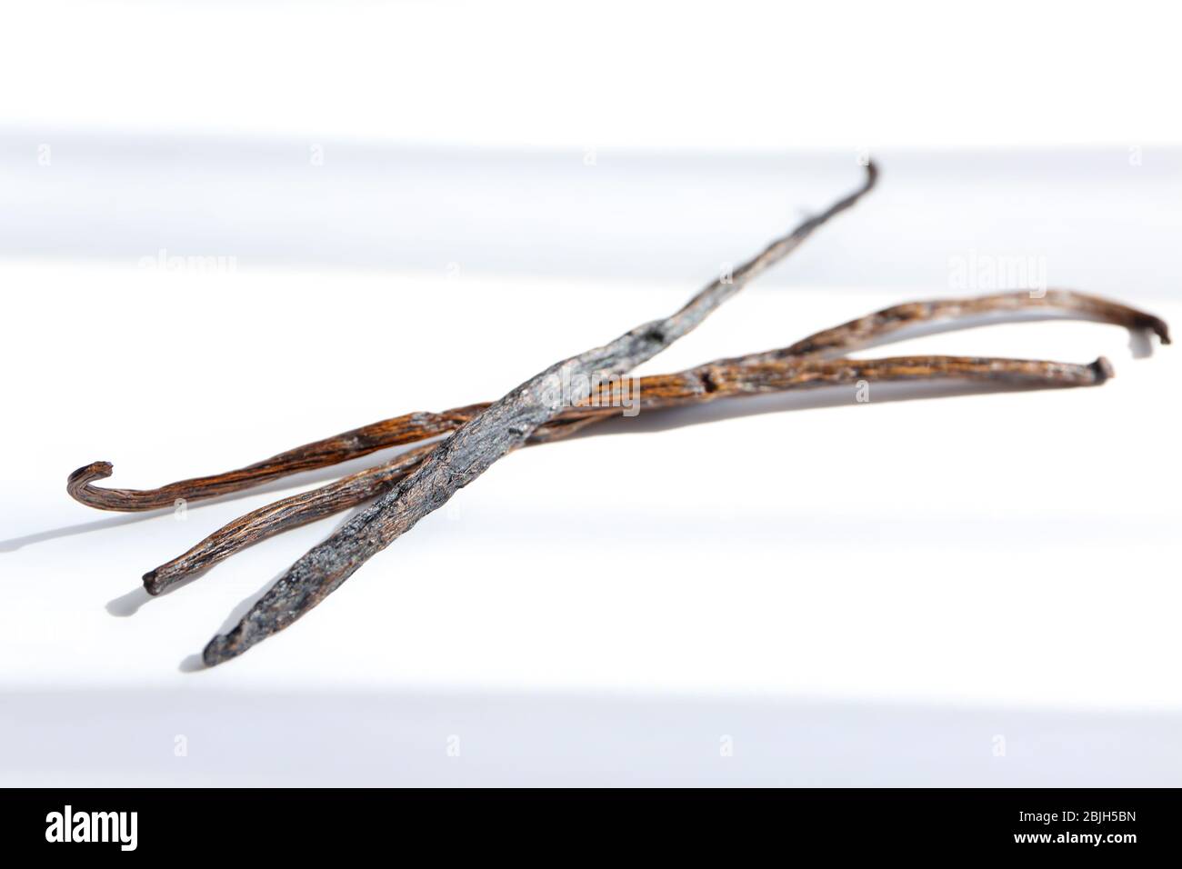 Vanilla pods on white background Stock Photo - Alamy