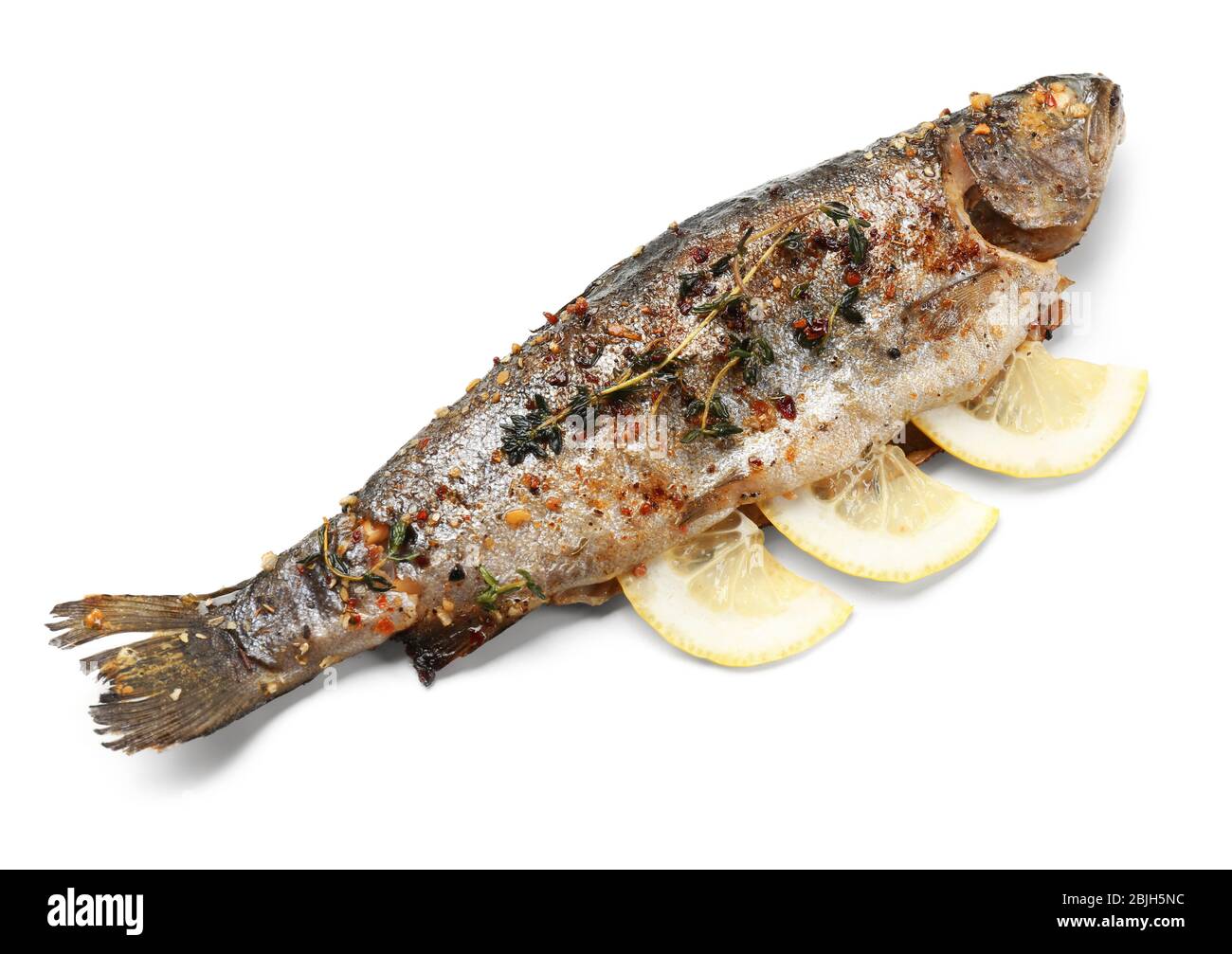 Delicious freshly fried fish with lemon slices on white background ...