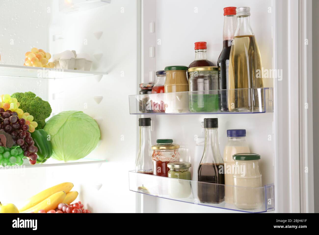 Different sauces on shelves in fridge Stock Photo - Alamy