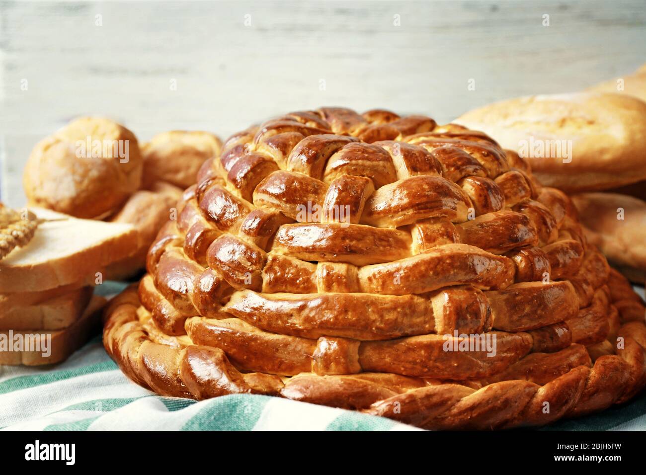 Baked round loaf and variety of bread on table Stock Photo - Alamy