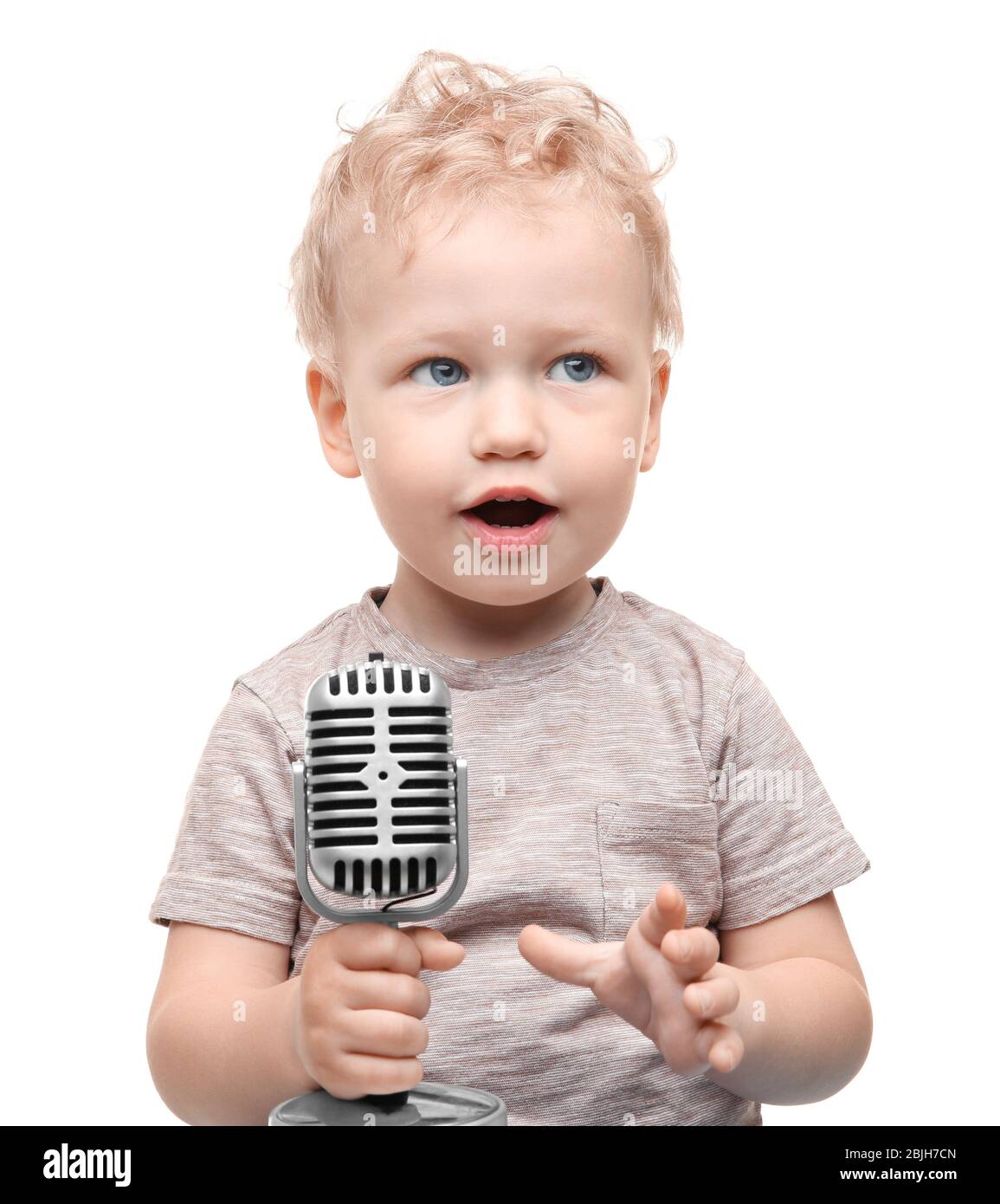 Cute little boy with microphone on white background Stock Photo - Alamy