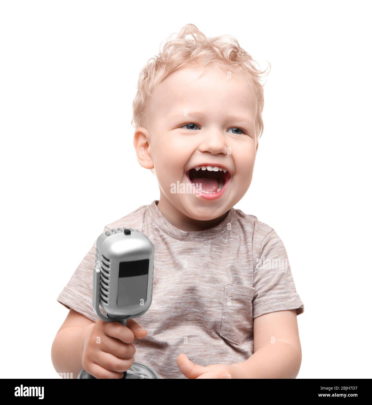 Cute little boy with microphone on white background Stock Photo - Alamy